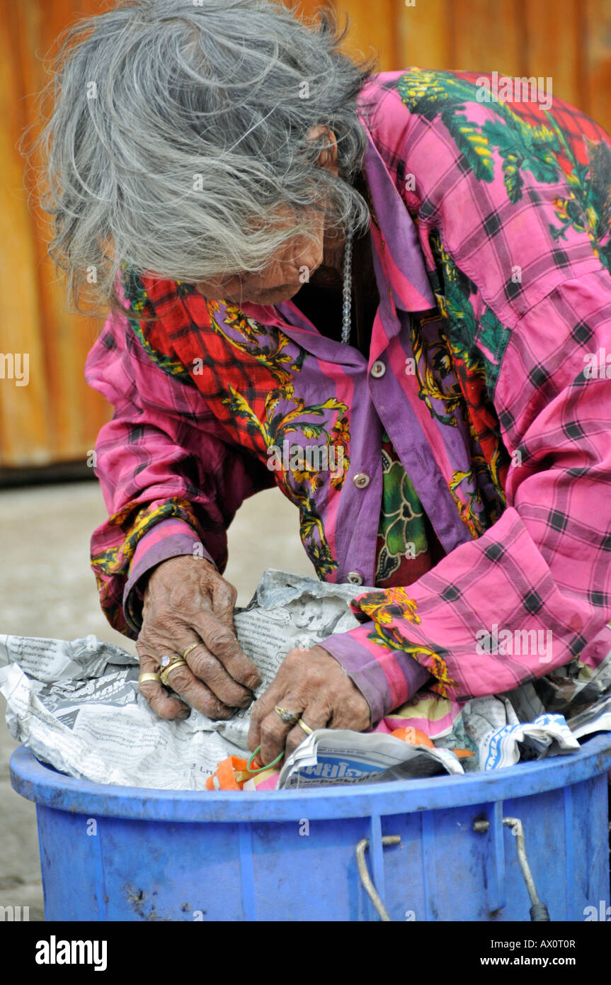 Old-age poverty: woman sorting through trash in Sukhothai, Thailand ...