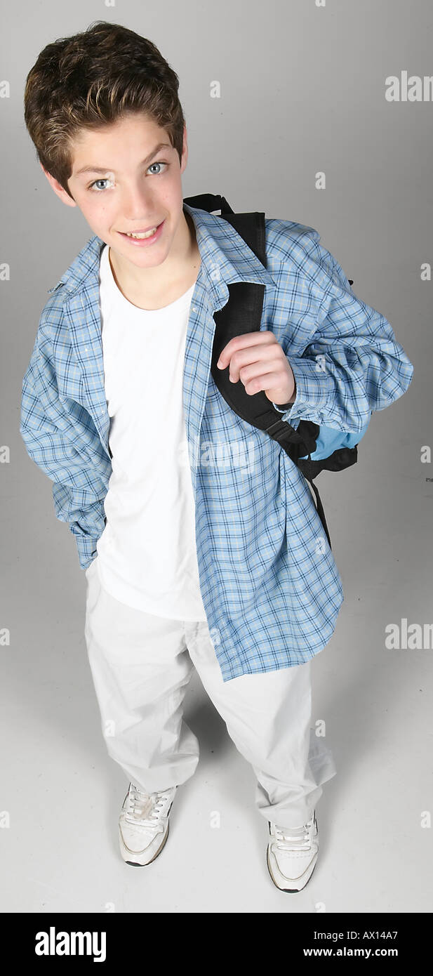 Smiling teenaged boy carrying backpack Stock Photo - Alamy