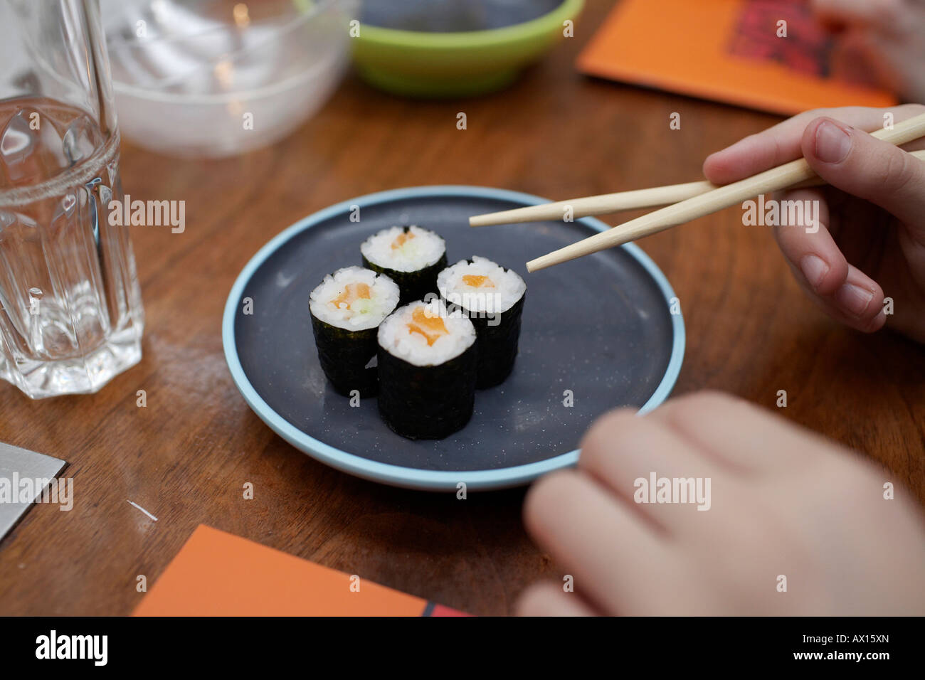 Diners sitting down to lunch at a Japanese Sushi bar Stock Photo - Alamy