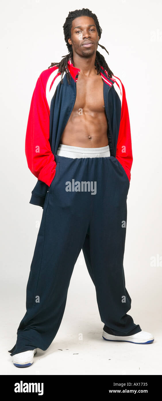 Standing man in red and blue track suit Stock Photo - Alamy