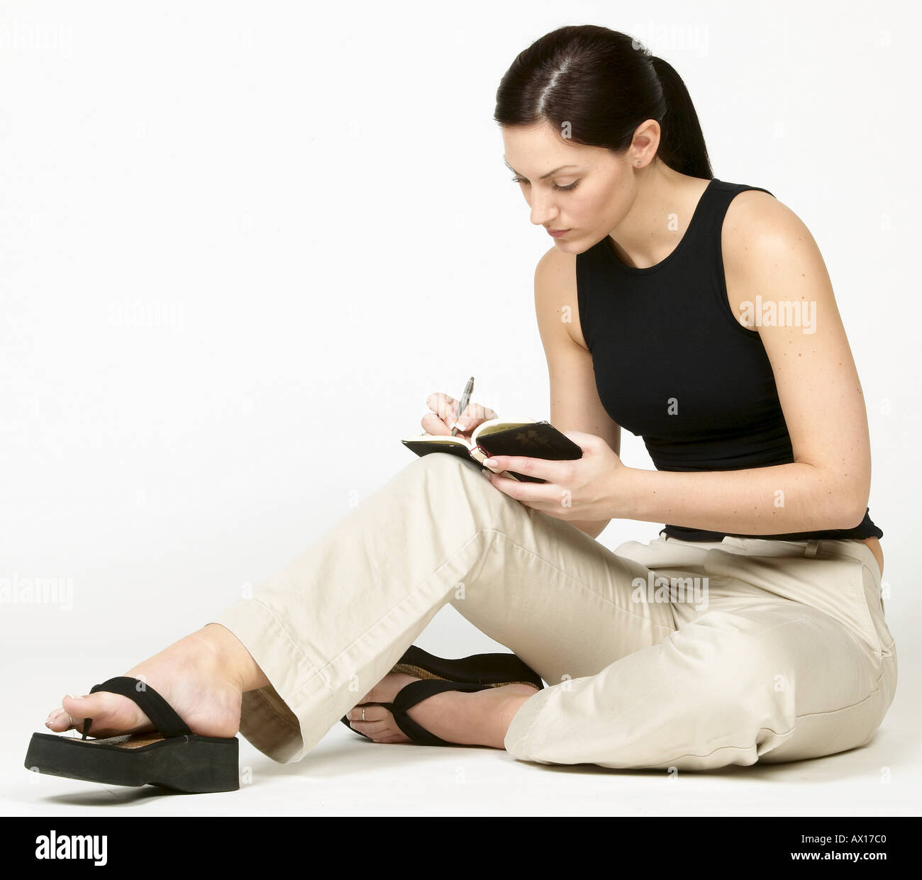 Seated woman book in hi-res stock photography and images - Alamy