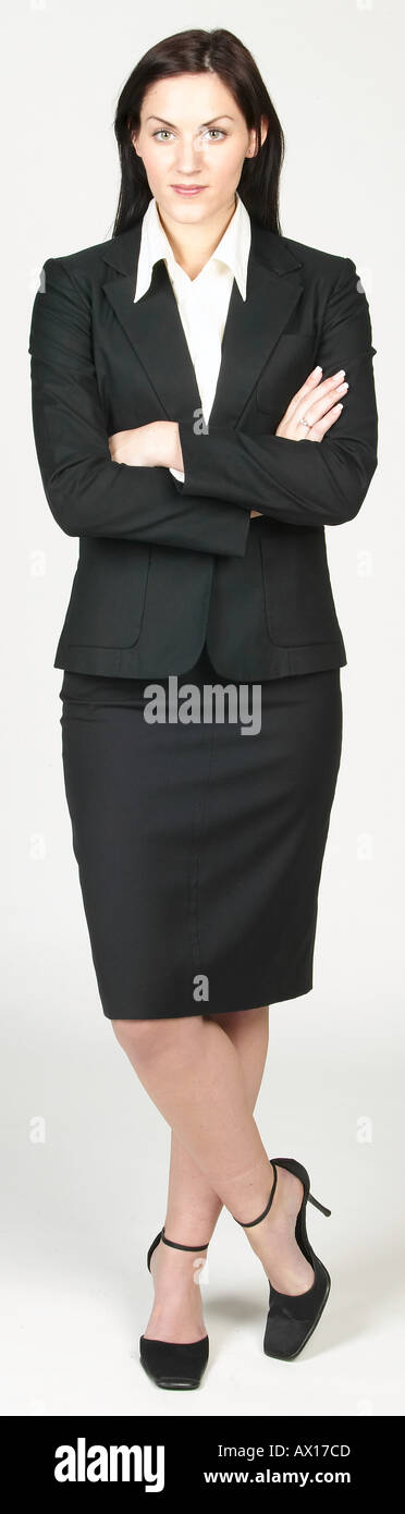 Confident businesswoman leaning on one leg Stock Photo - Alamy