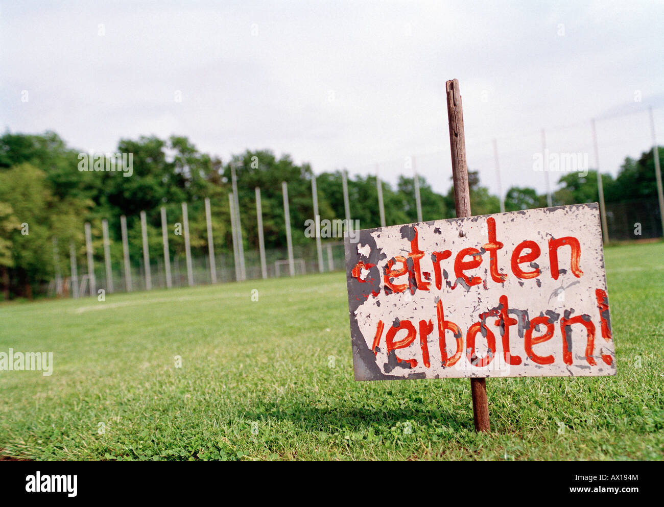 Warning sign in a field grass Stock Photo - Alamy