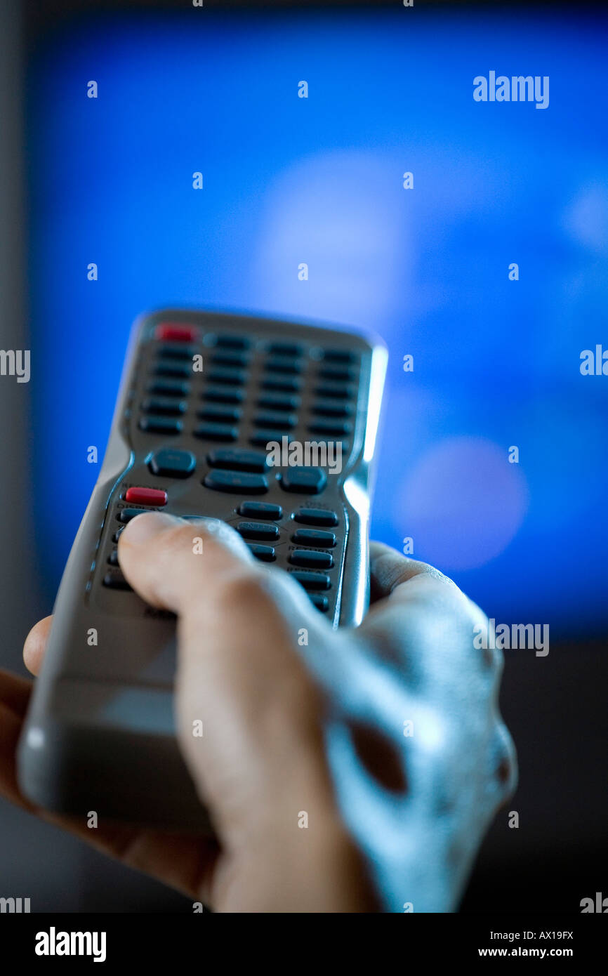Hand holding a remote control Stock Photo - Alamy
