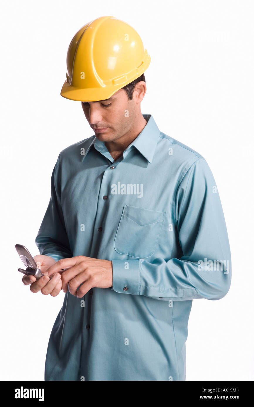 A man wearing a safety helmet and using a mobile phone Stock Photo - Alamy