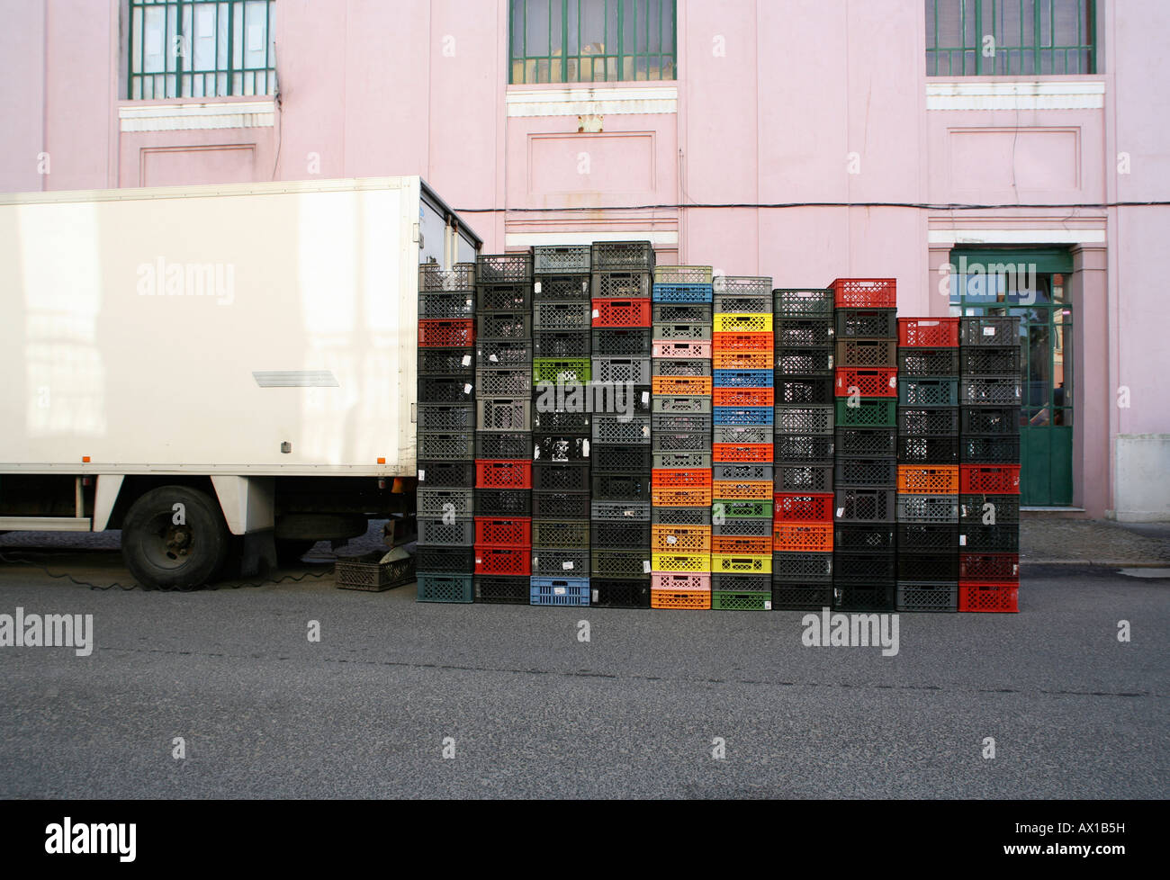 Stack of crates next to a delivery truck Stock Photo - Alamy