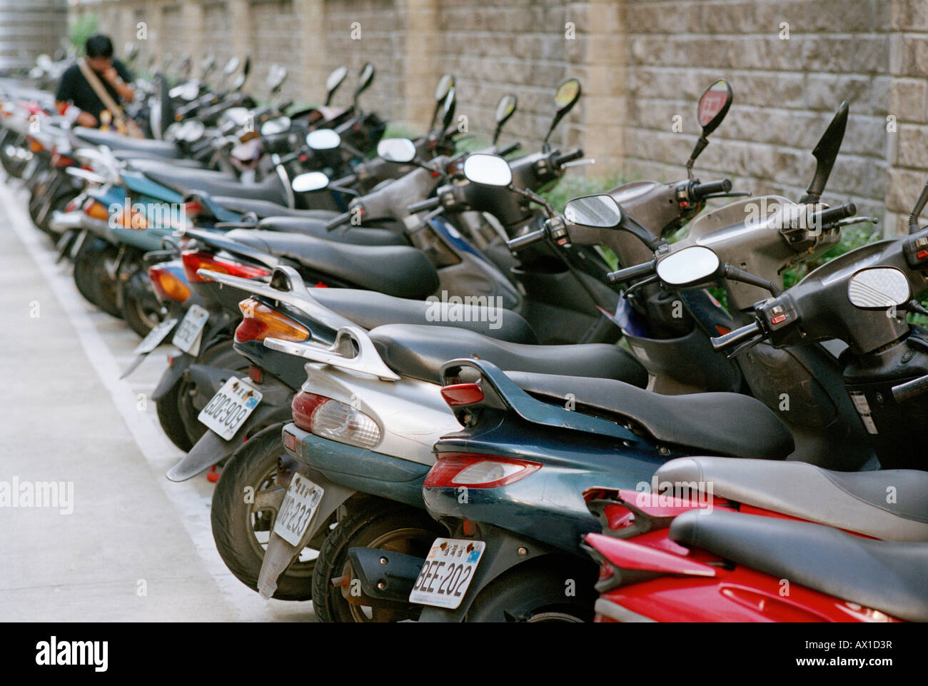 Scooters parked in a row Stock Photo - Alamy