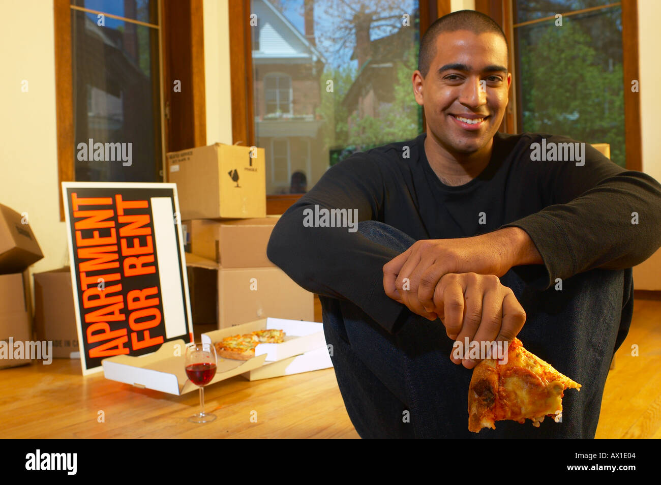 Man having pizza and red wine in empty apartment Stock Photo - Alamy