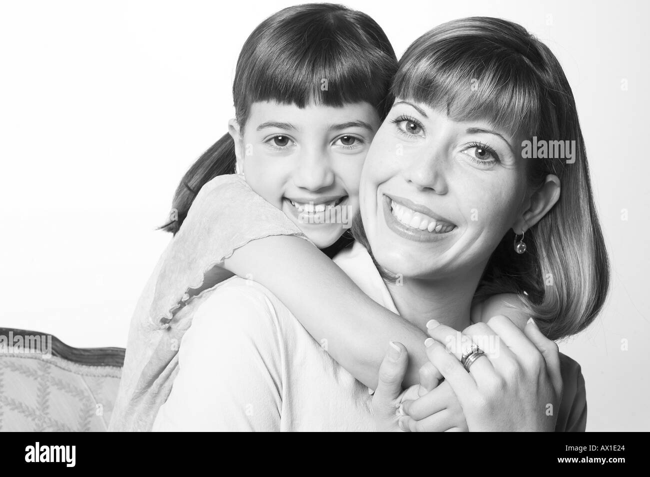 Embracing mother and daughter Stock Photo - Alamy