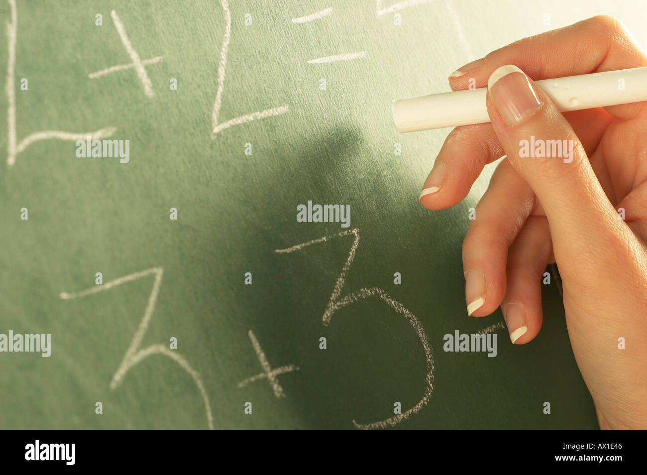 Teacher writing math equation on chalkboard 1 Stock Photo - Alamy