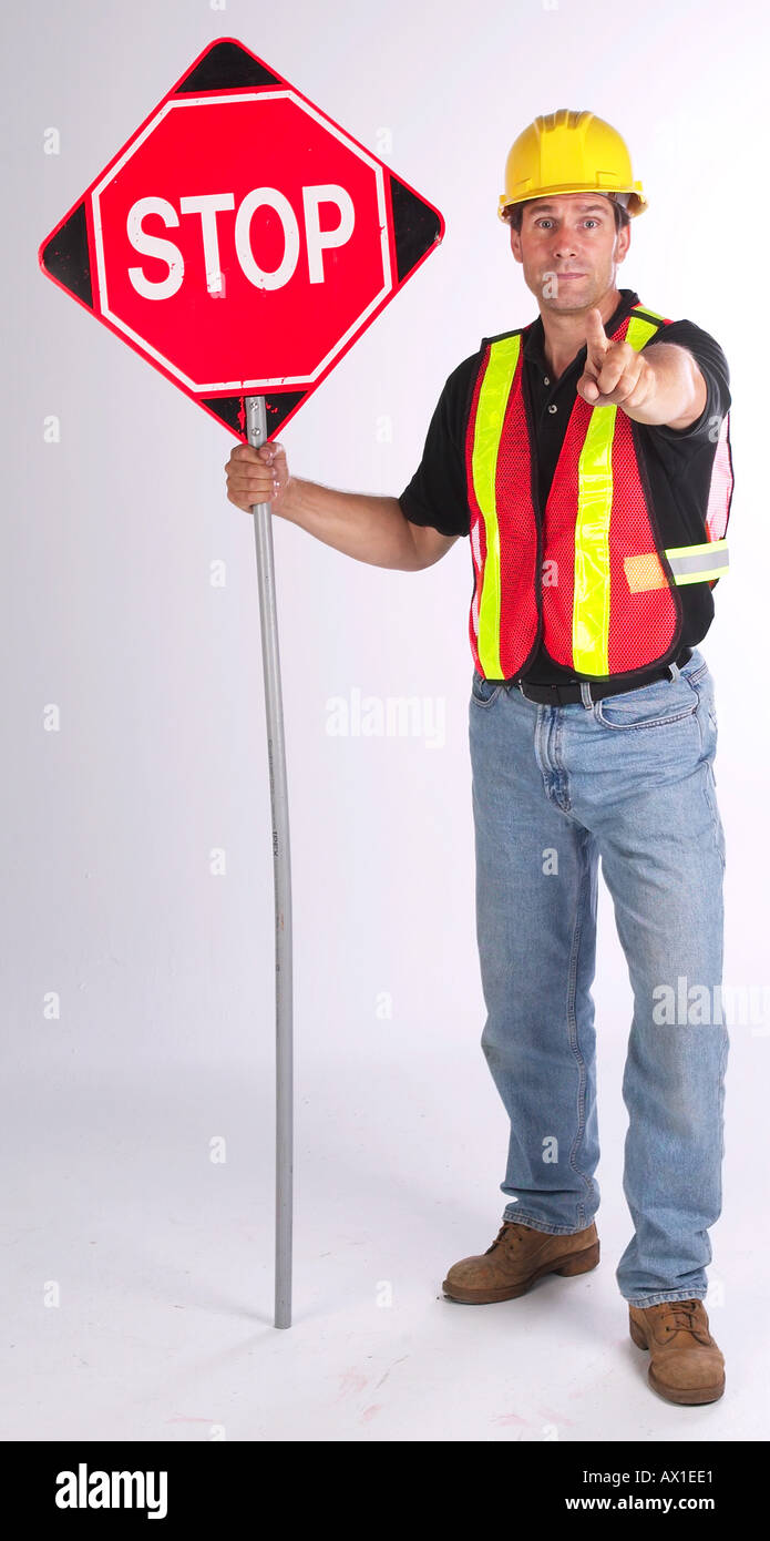 Construction worker holding out stop sign Stock Photo - Alamy