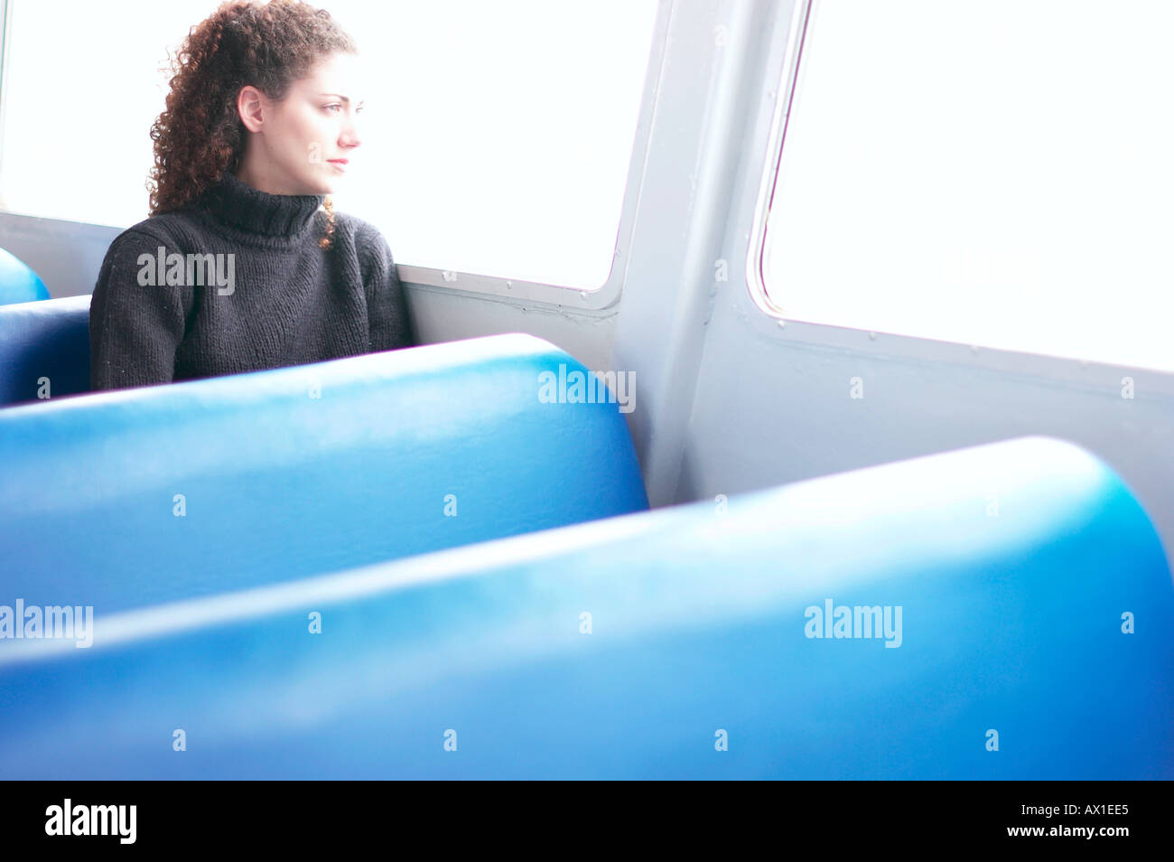 Woman looking out bus window Stock Photo - Alamy