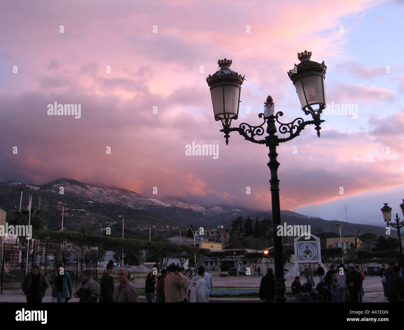 Old french style lamp post at sunset, back the snowy Chrea mountains ...