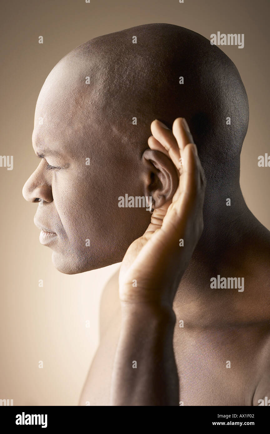 Man listening with his hand to his ear Stock Photo - Alamy