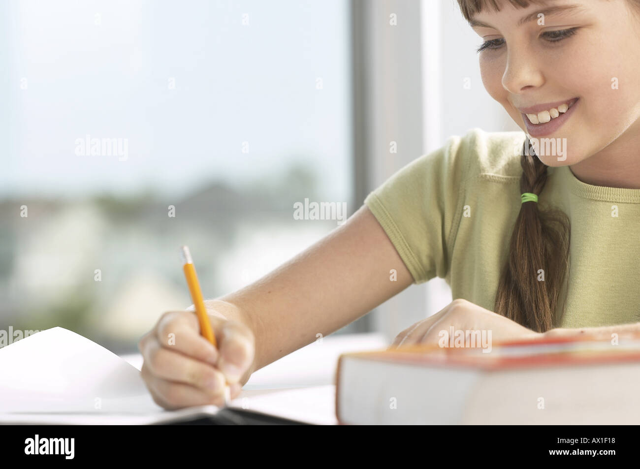 Little girl writing at her desk 1 Stock Photo - Alamy