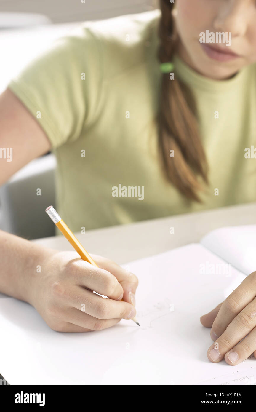 Little girl writing at her desk 6 Stock Photo - Alamy