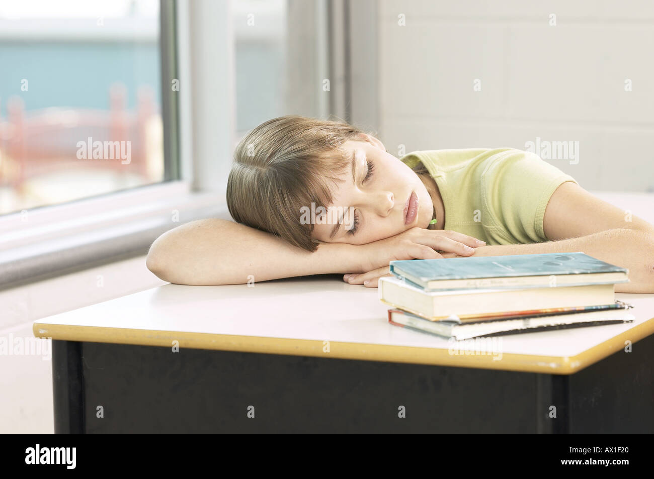 Little girl taking nap at her desk Stock Photo - Alamy