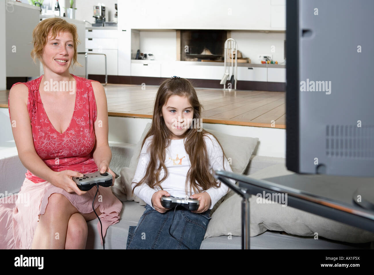 A mother and daughter playing a computer game together Stock Photo - Alamy