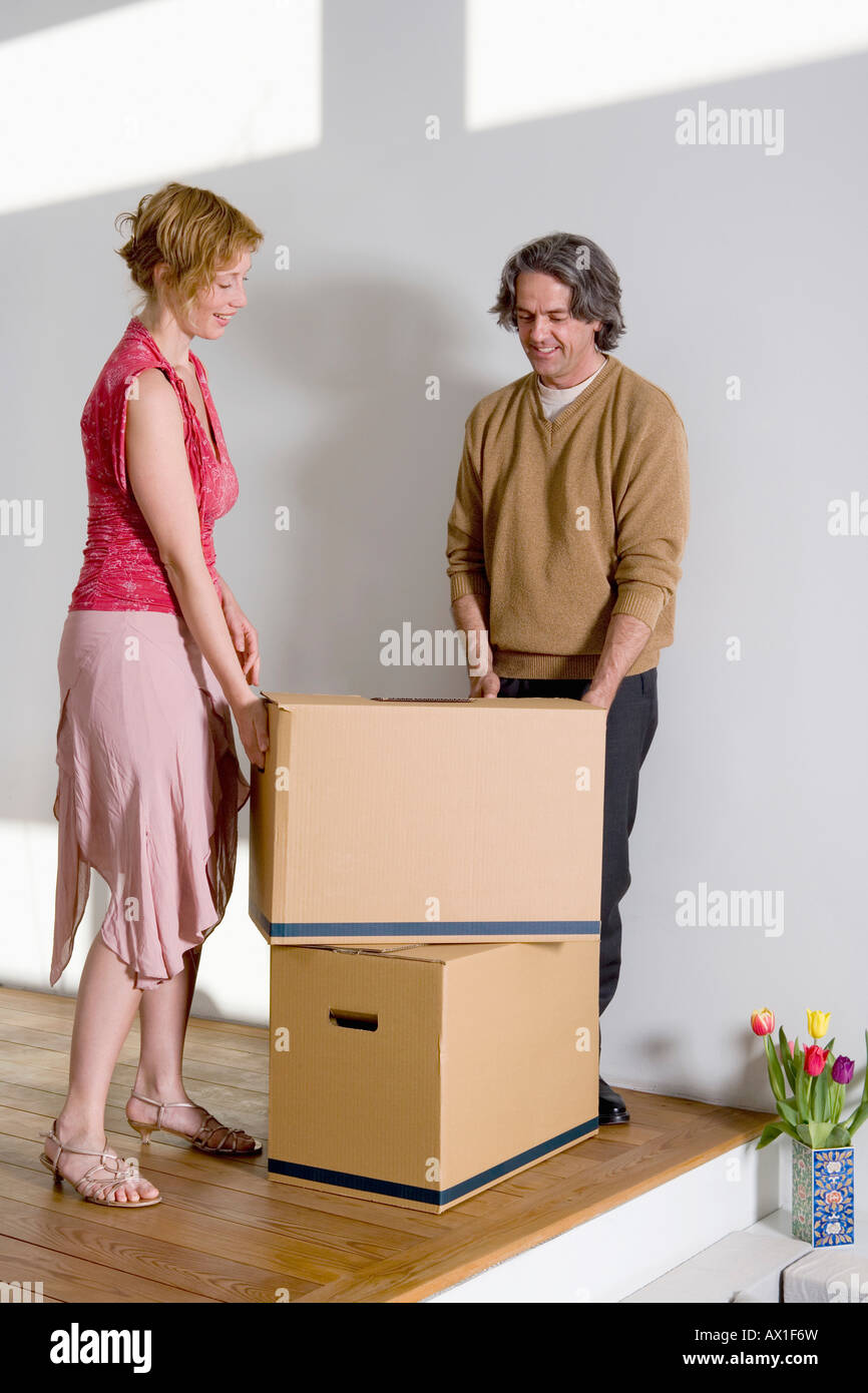 A couple standing next to cardboard boxes Stock Photo - Alamy