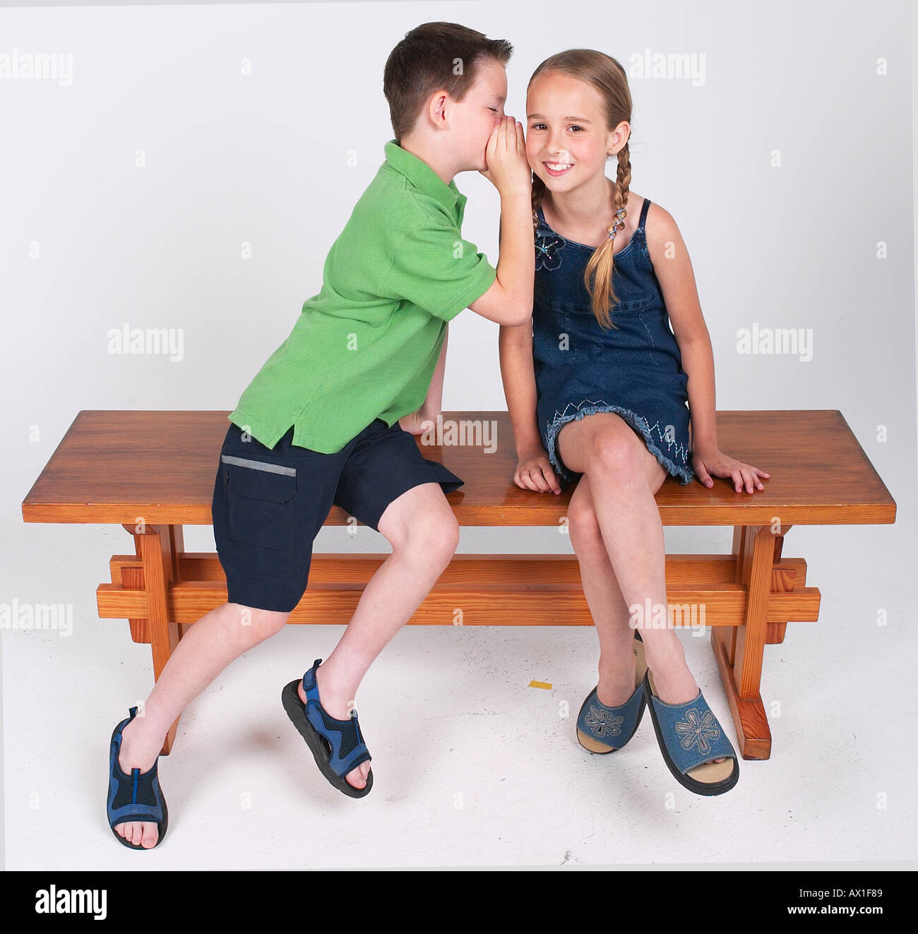 Children telling secrets hi-res stock photography and images - Alamy