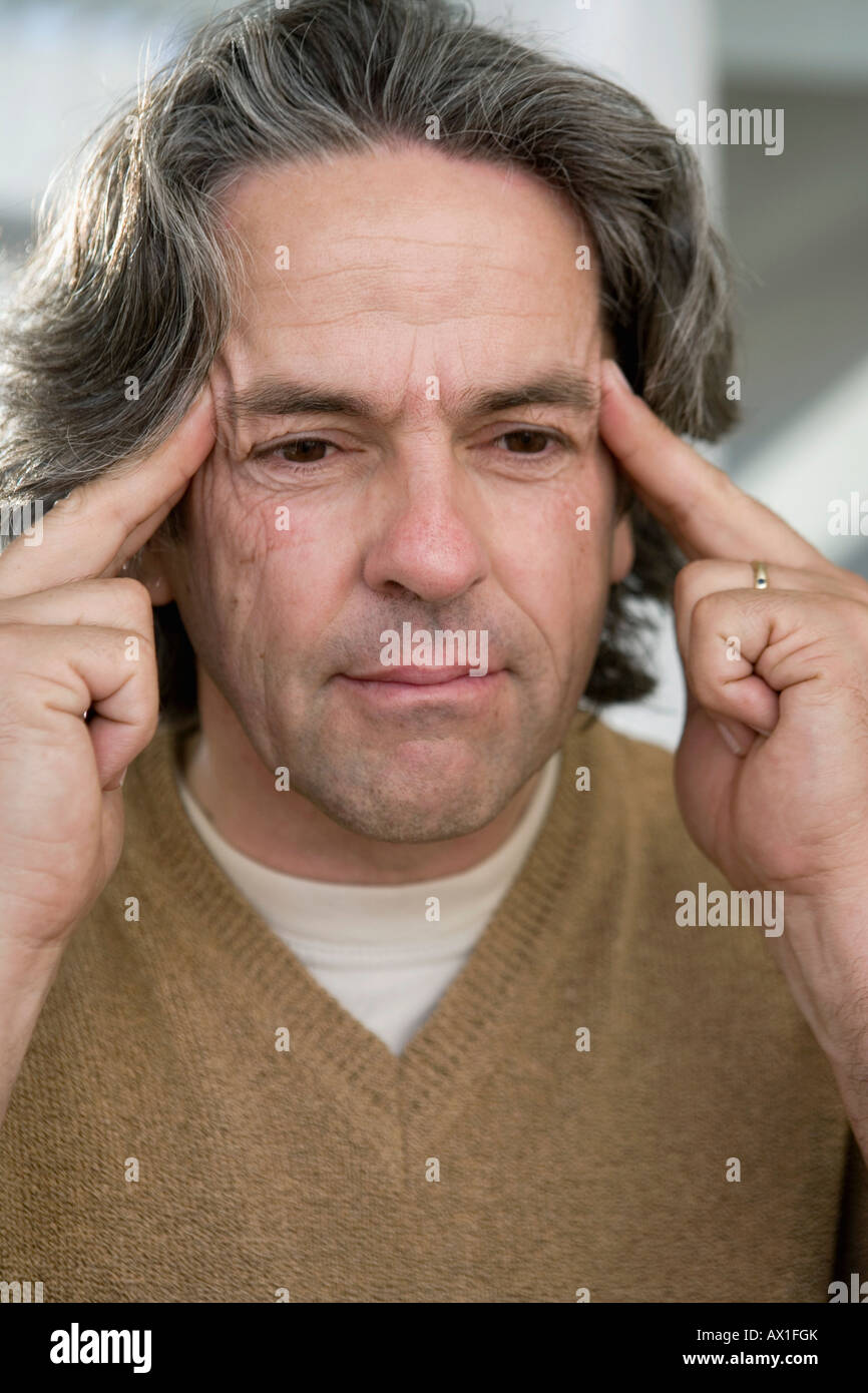 Mature man rubbing temples hi-res stock photography and images - Alamy