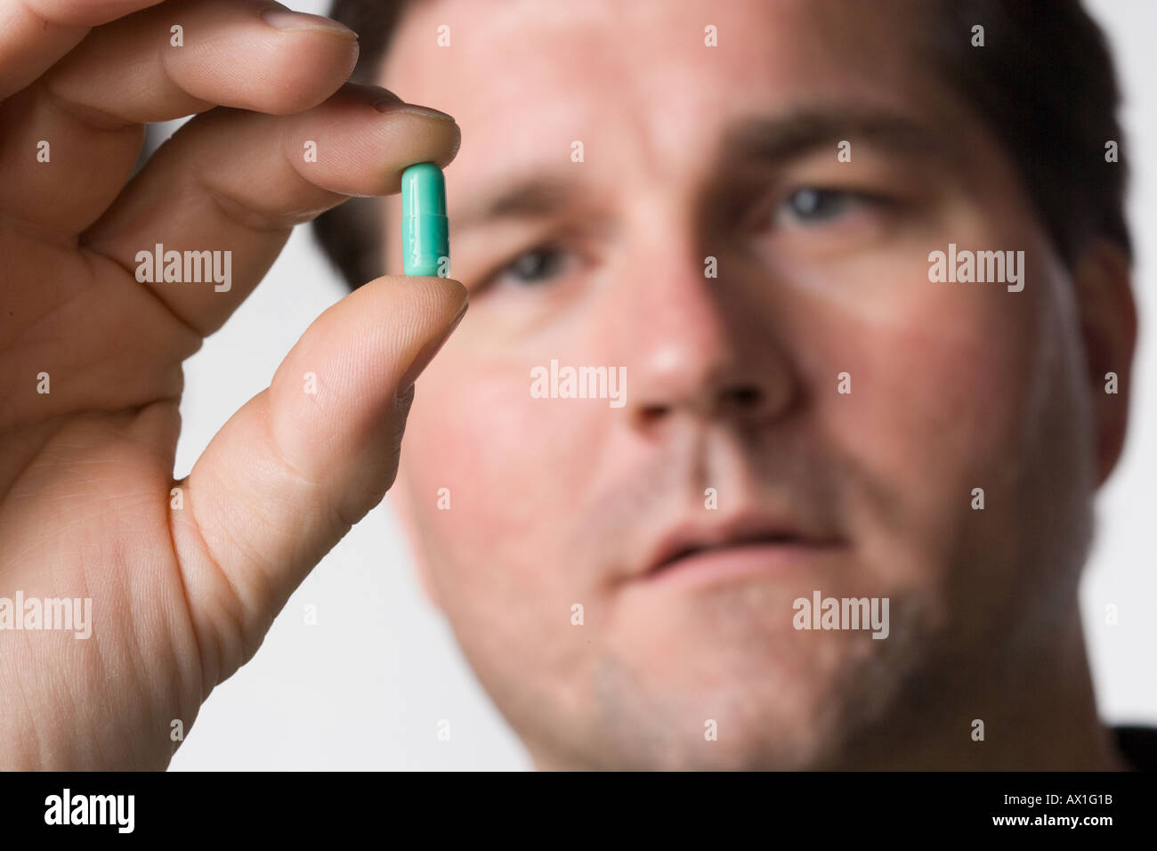 Portrait Caucasian man holding pharmaceutical capsule Stock Photo - Alamy
