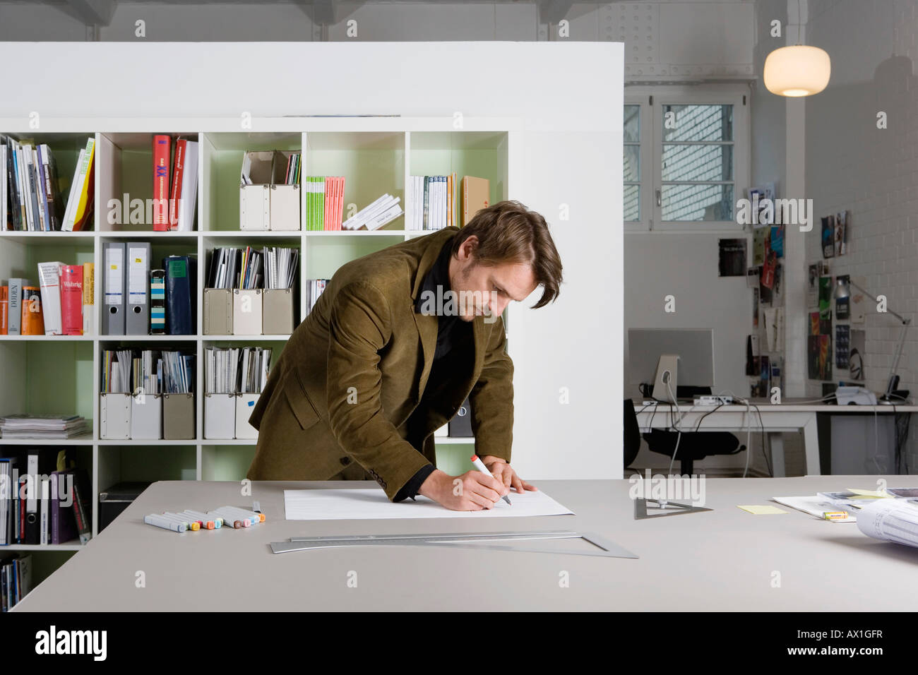 Business a man standing over a desk hi-res stock photography and images ...