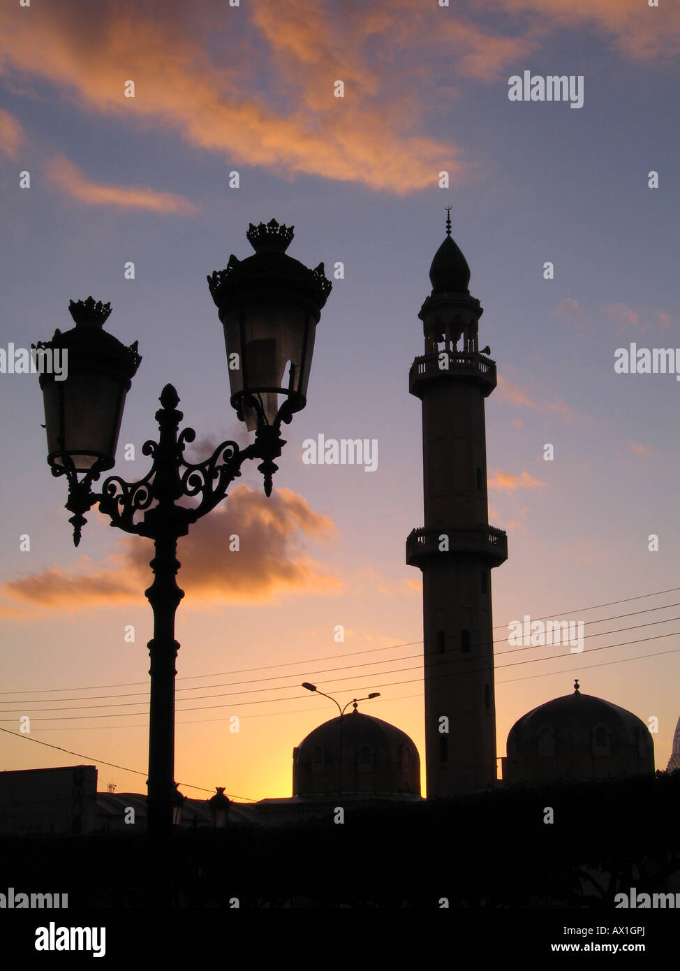 Minaret of mosque and an old french style lamp post. Blida called ...