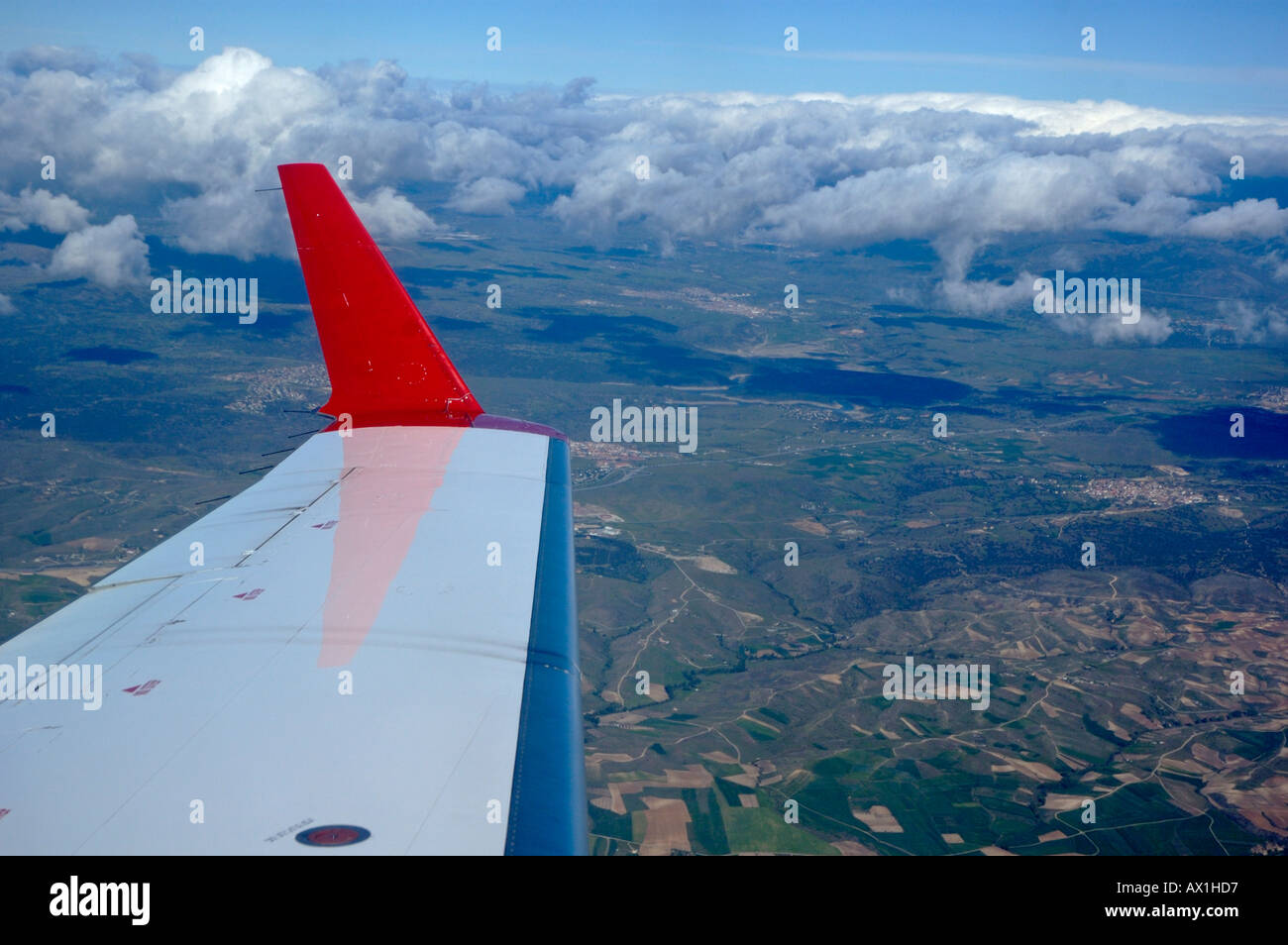 Wing of an airplane mid flight over Spain Stock Photo - Alamy