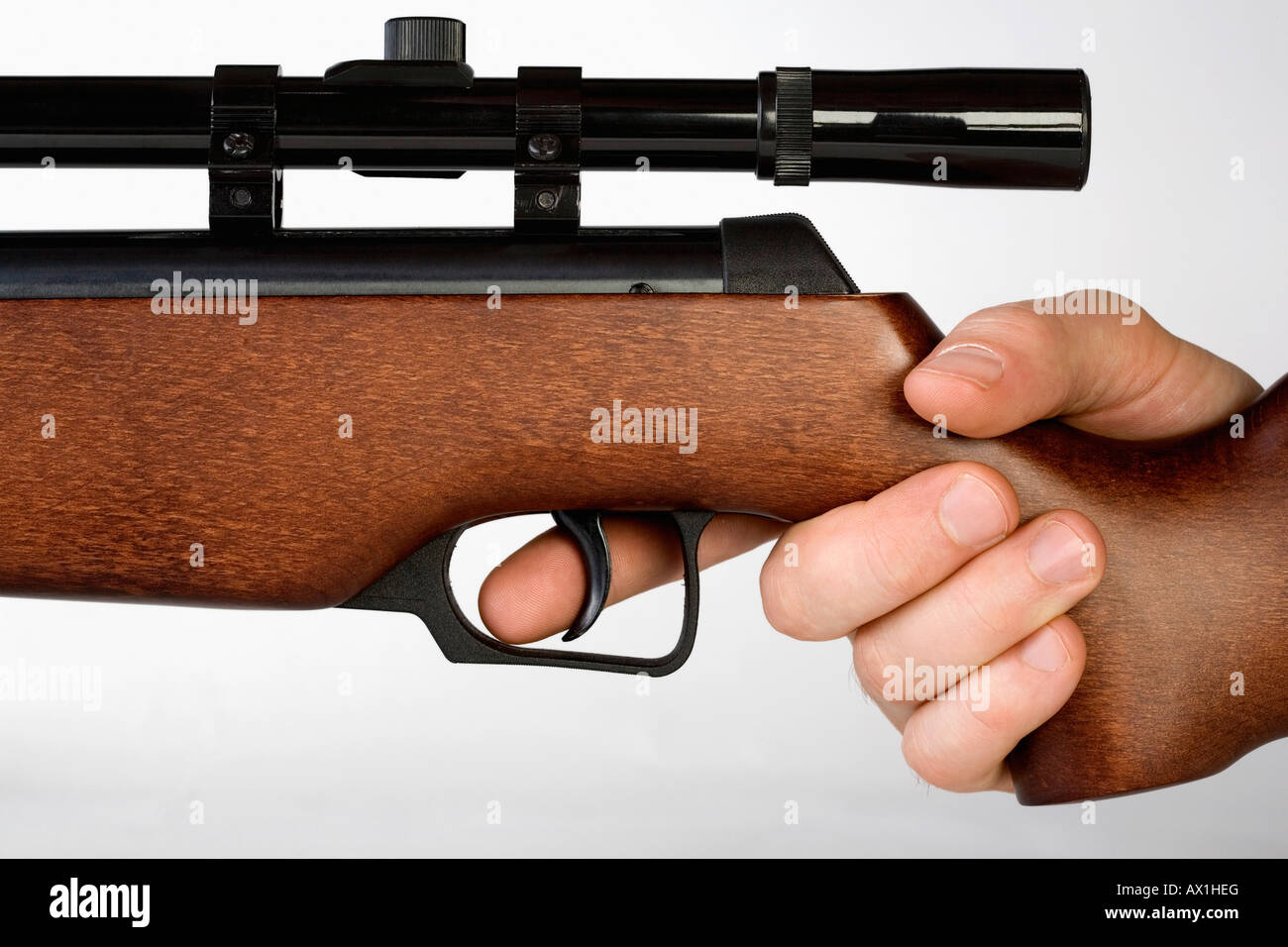 A hand holding a gun Stock Photo - Alamy