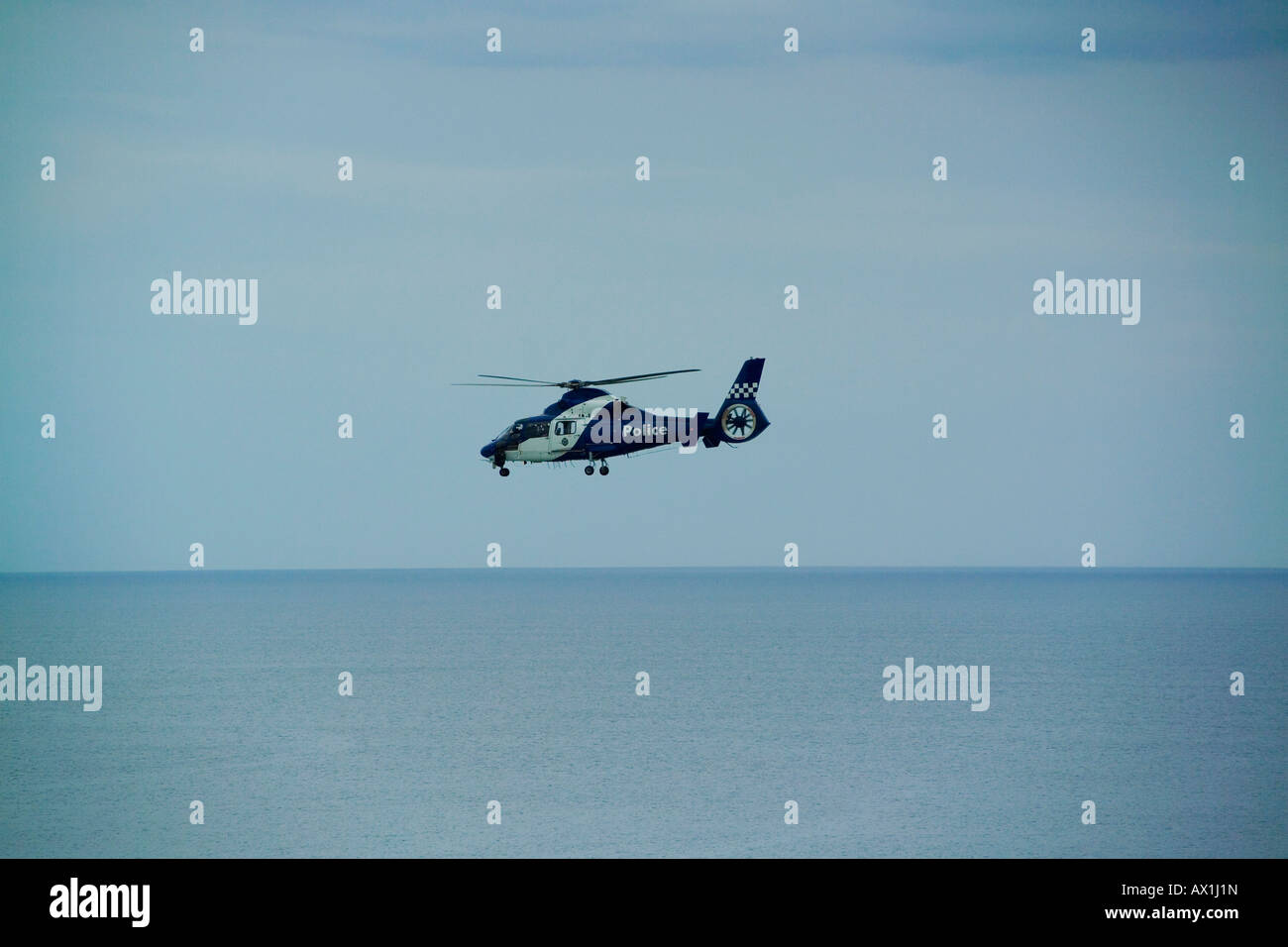 A Police helicopter flying over the sea Stock Photo - Alamy
