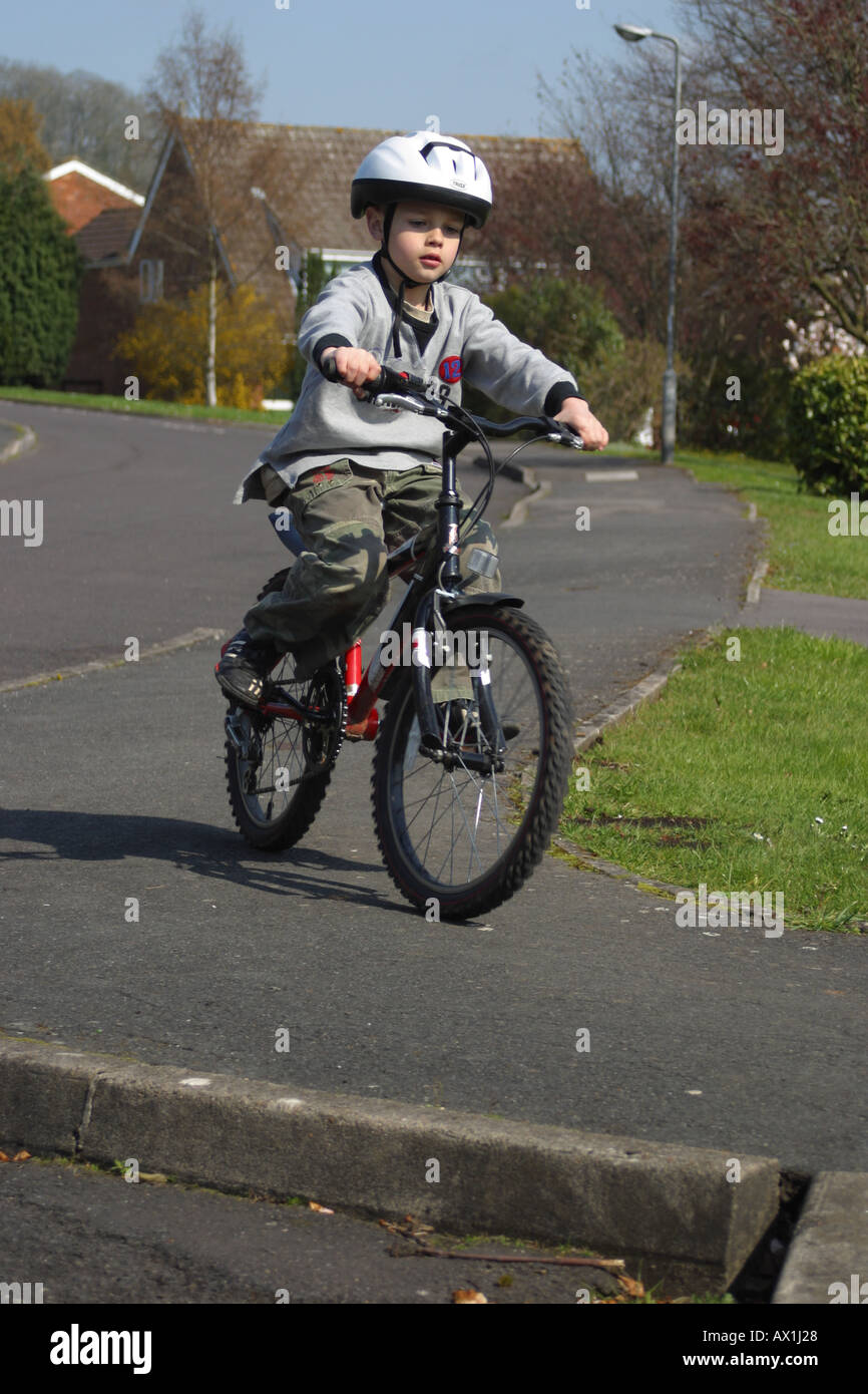 Young boy learning to ride a bicycle Stock Photo - Alamy