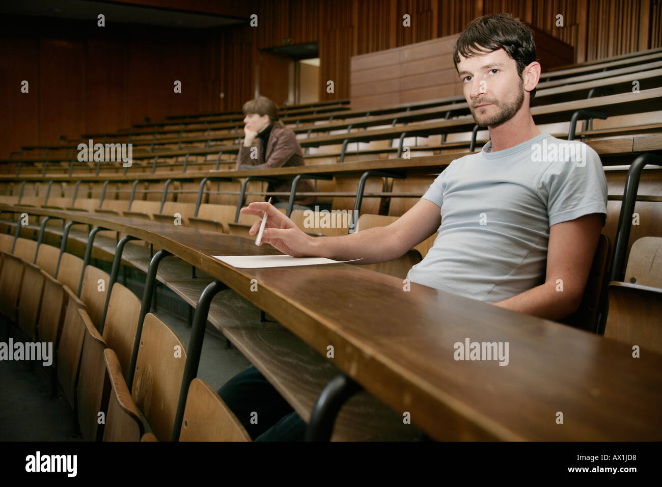 Two people sitting in a lecture hall Stock Photo - Alamy
