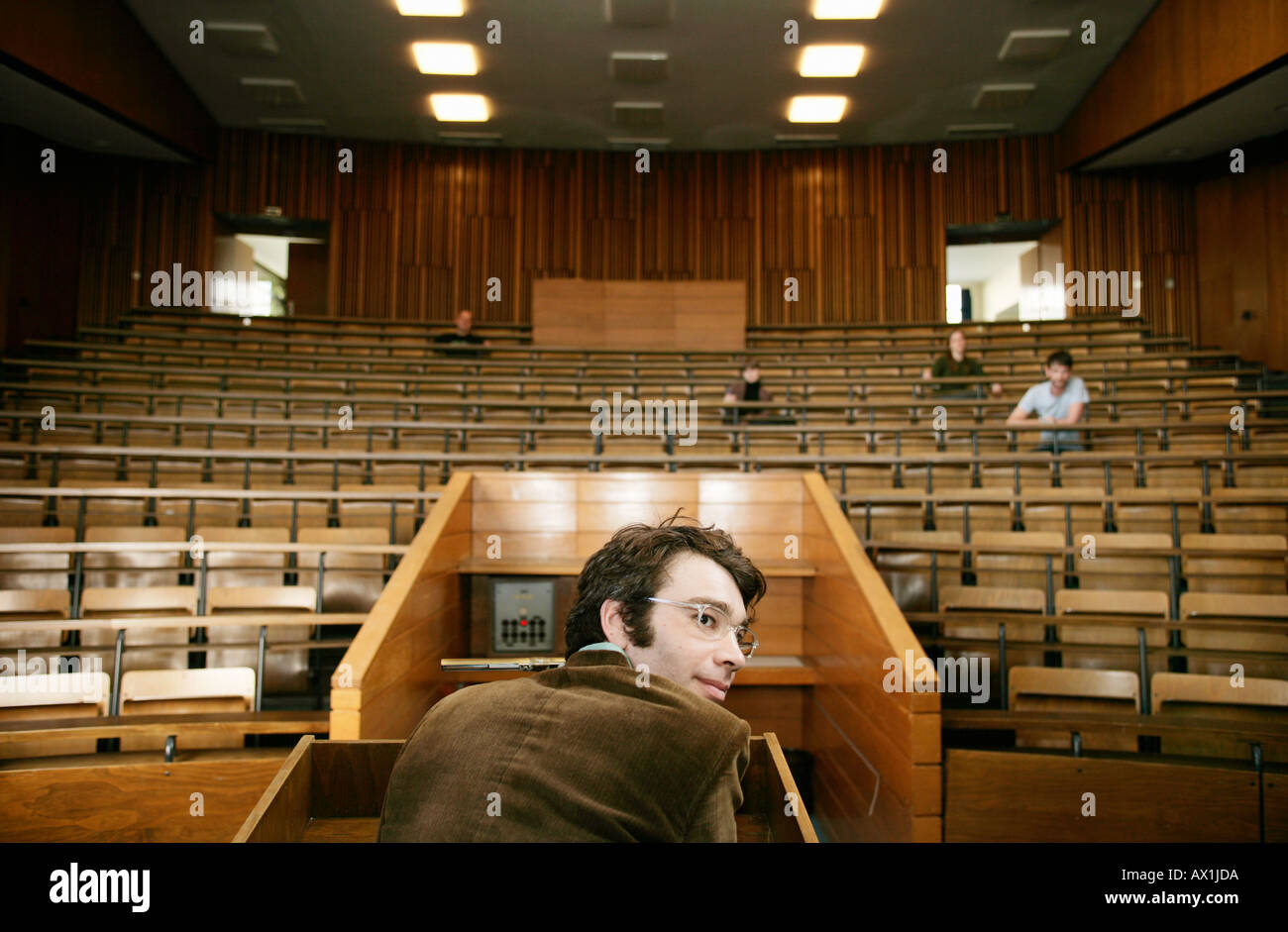 A professor looking over his shoulder in a lecture hall Stock Photo - Alamy