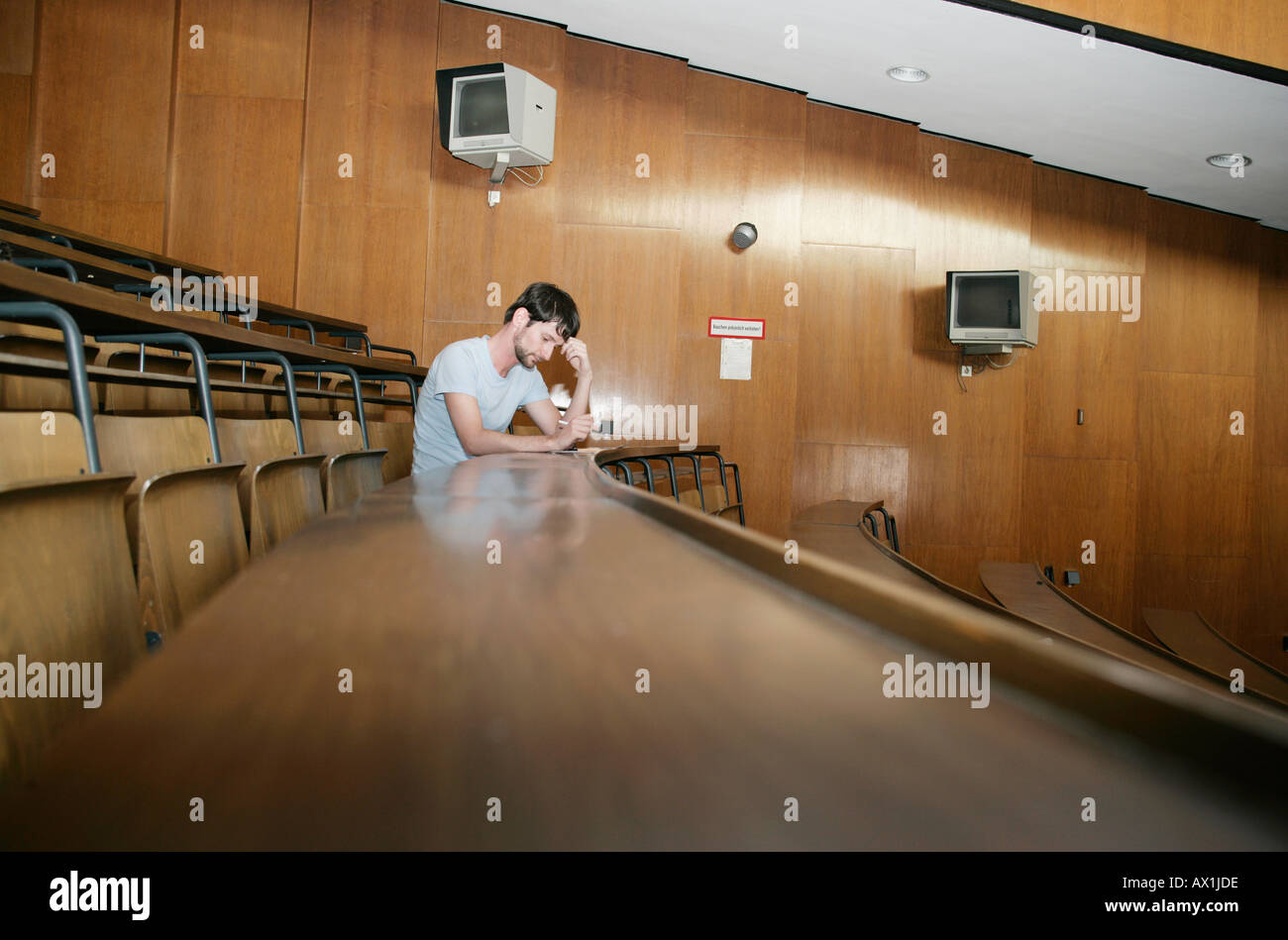 A man studying in a lecture hall Stock Photo - Alamy
