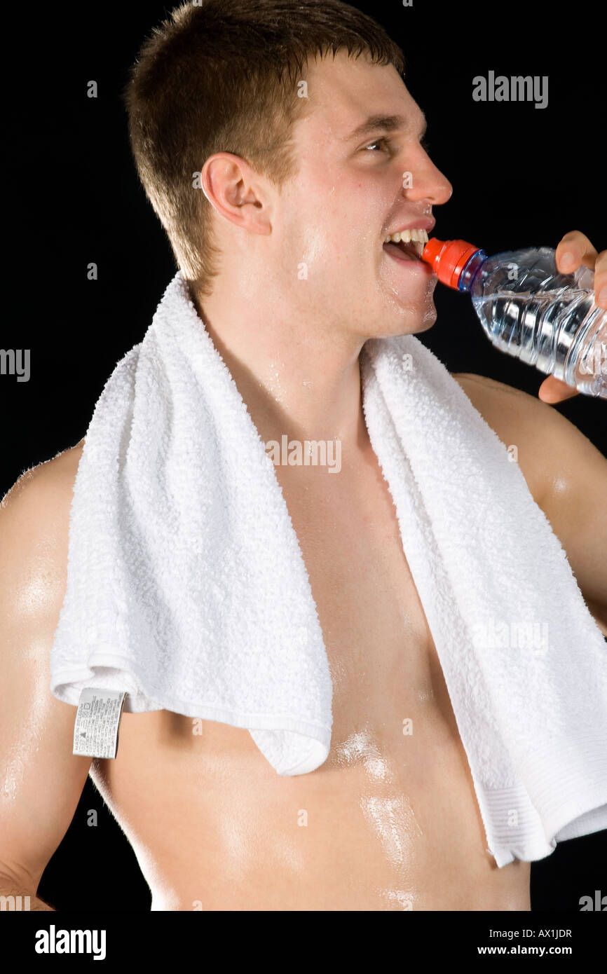 A man drinking water and sweating Stock Photo - Alamy