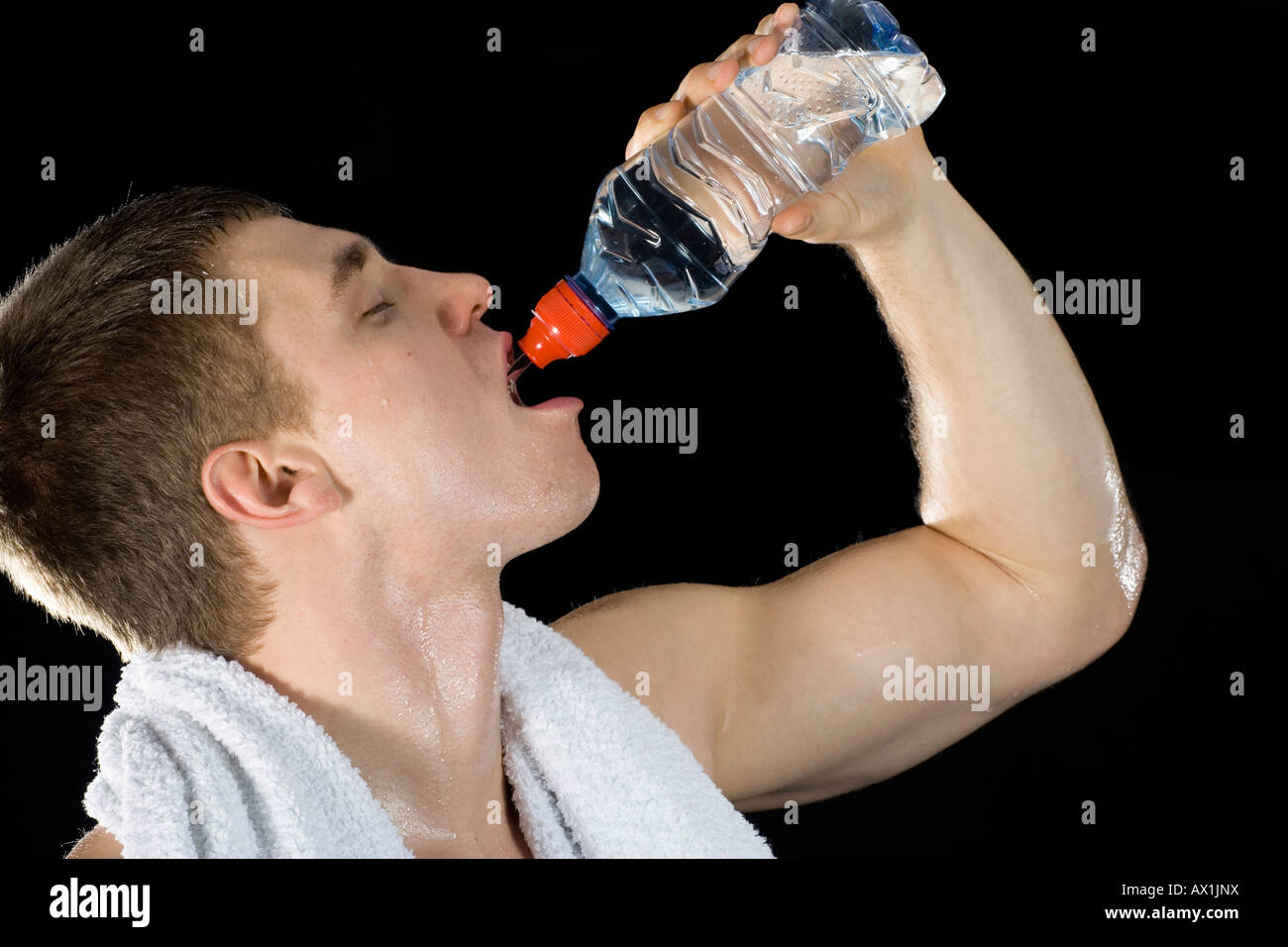 A man drinking water and sweating Stock Photo - Alamy