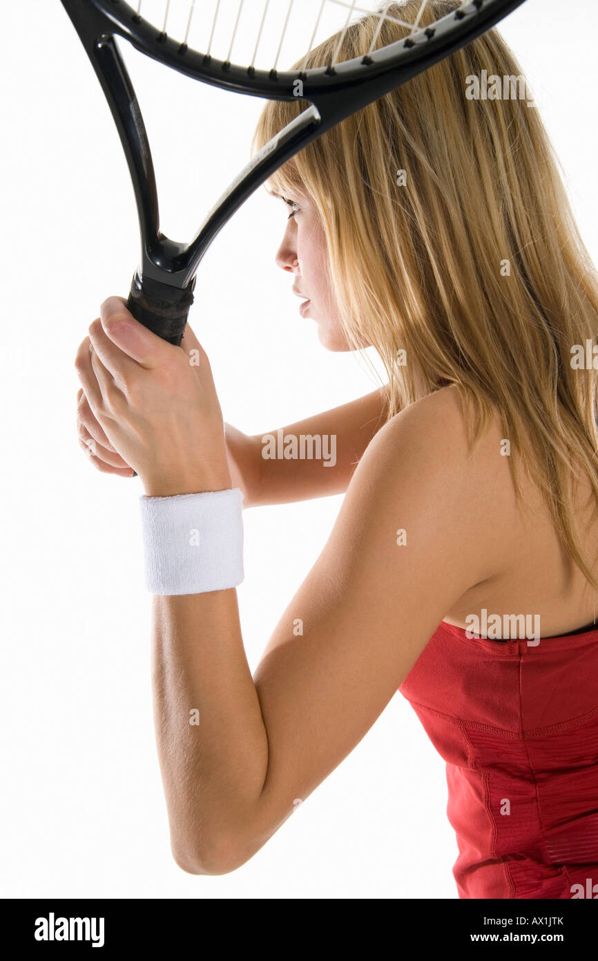 A close-up studio shot of a female tennis player holding a tennis ...