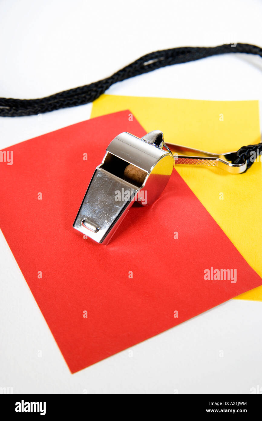 still life studio shot of a sports whistle, a red penalty card and a ...