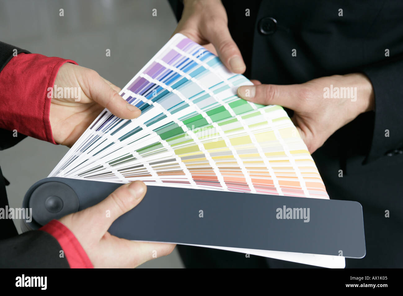Woman and man holding color swatches Stock Photo - Alamy
