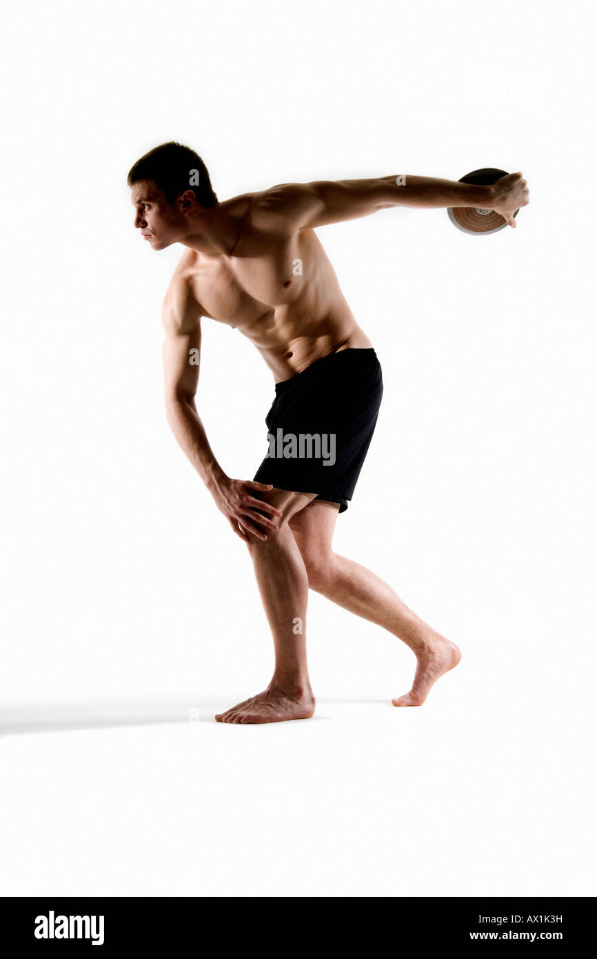 Studio portrait of a male discus thrower holding a discus Stock Photo ...