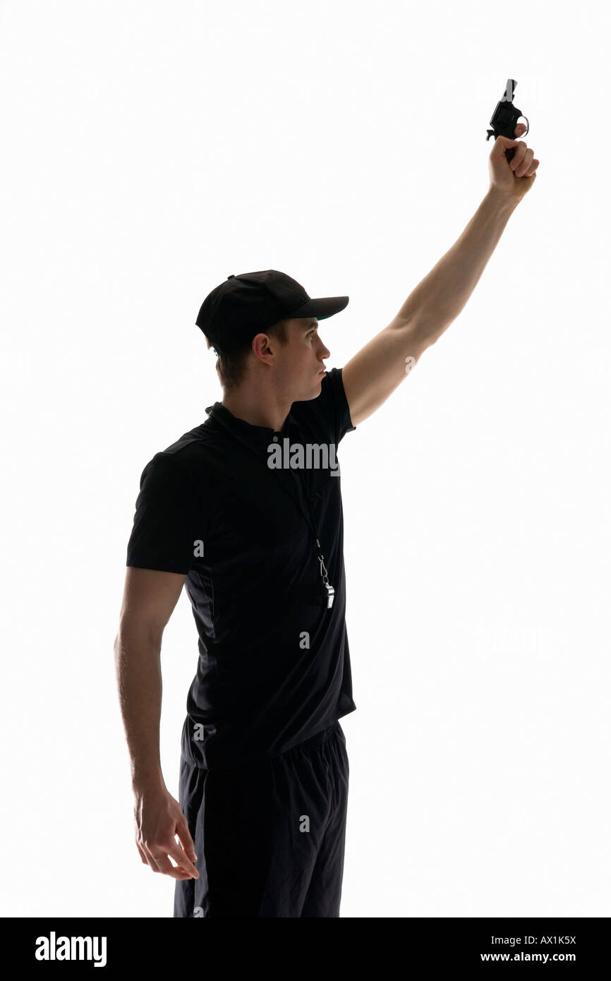 Studio shot of referee holding a starting gun Stock Photo - Alamy