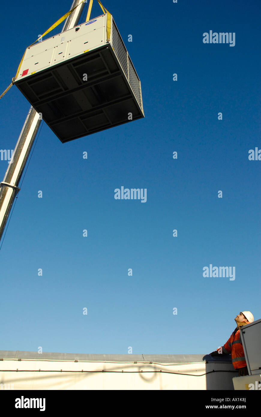 Crane delivery being supervised Stock Photo - Alamy