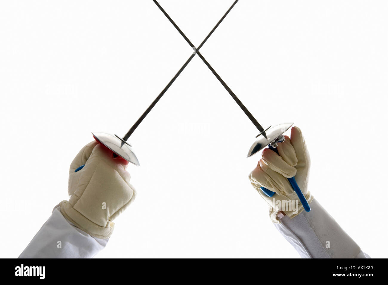 Two human hands holding fencing foils in confrontation Stock Photo - Alamy
