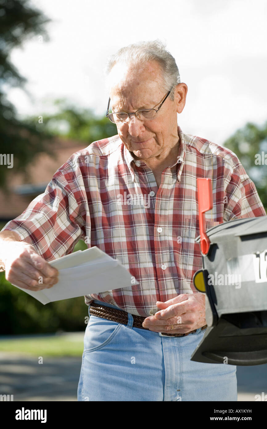 A senior man checking the mailbox Stock Photo - Alamy