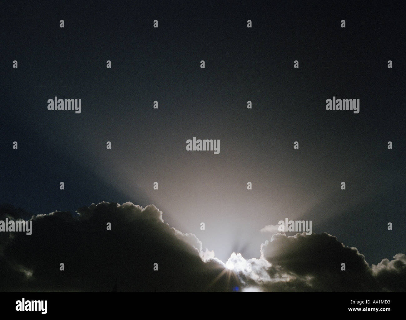 Sunlight breaking through clouds Stock Photo - Alamy