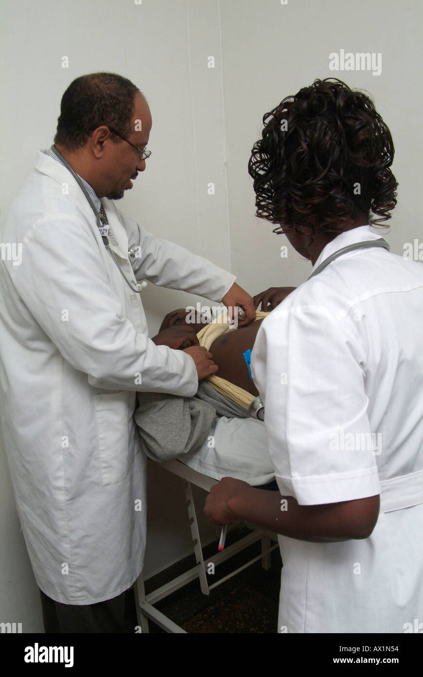 Doctor examining patient Stock Photo - Alamy