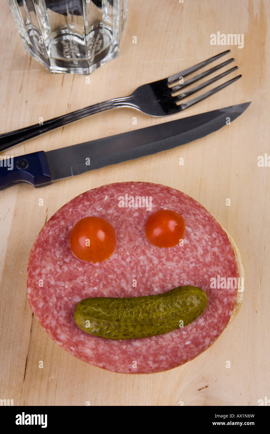 An anthropomorphic face on a slice of salami Stock Photo - Alamy
