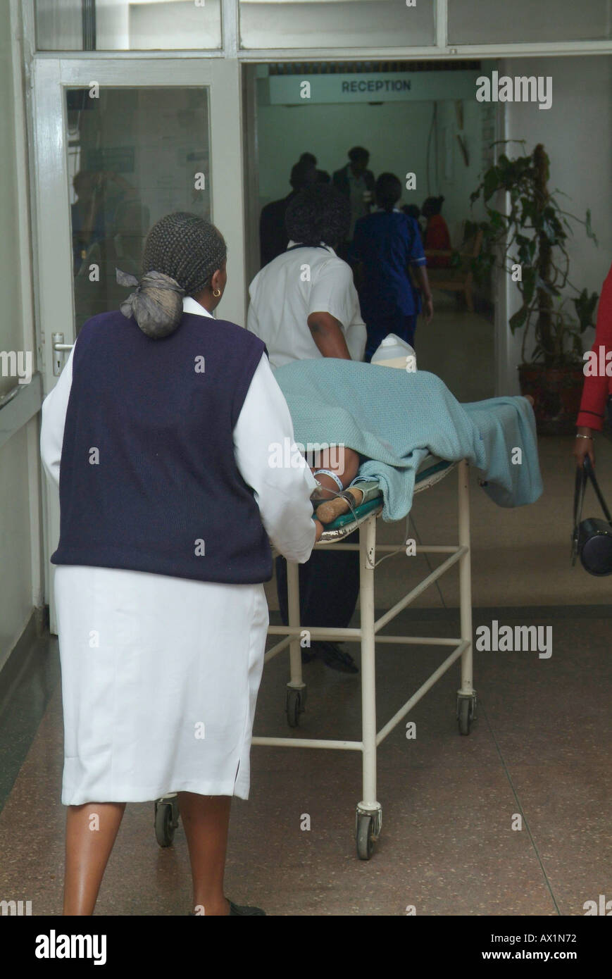Nurses wheeling patient Stock Photo - Alamy