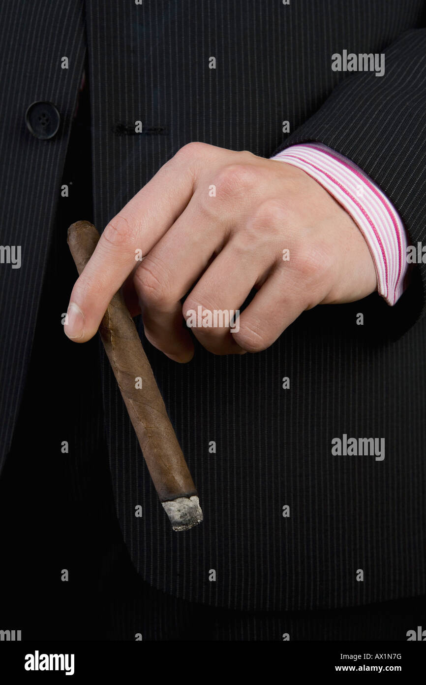 A businessman holding a cigar Stock Photo - Alamy
